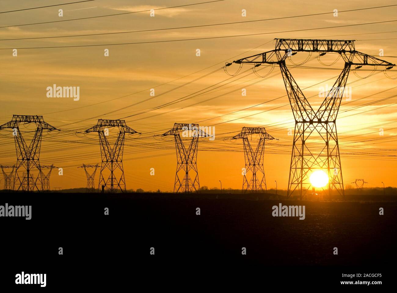 Power lines at sunset Stock Photo - Alamy