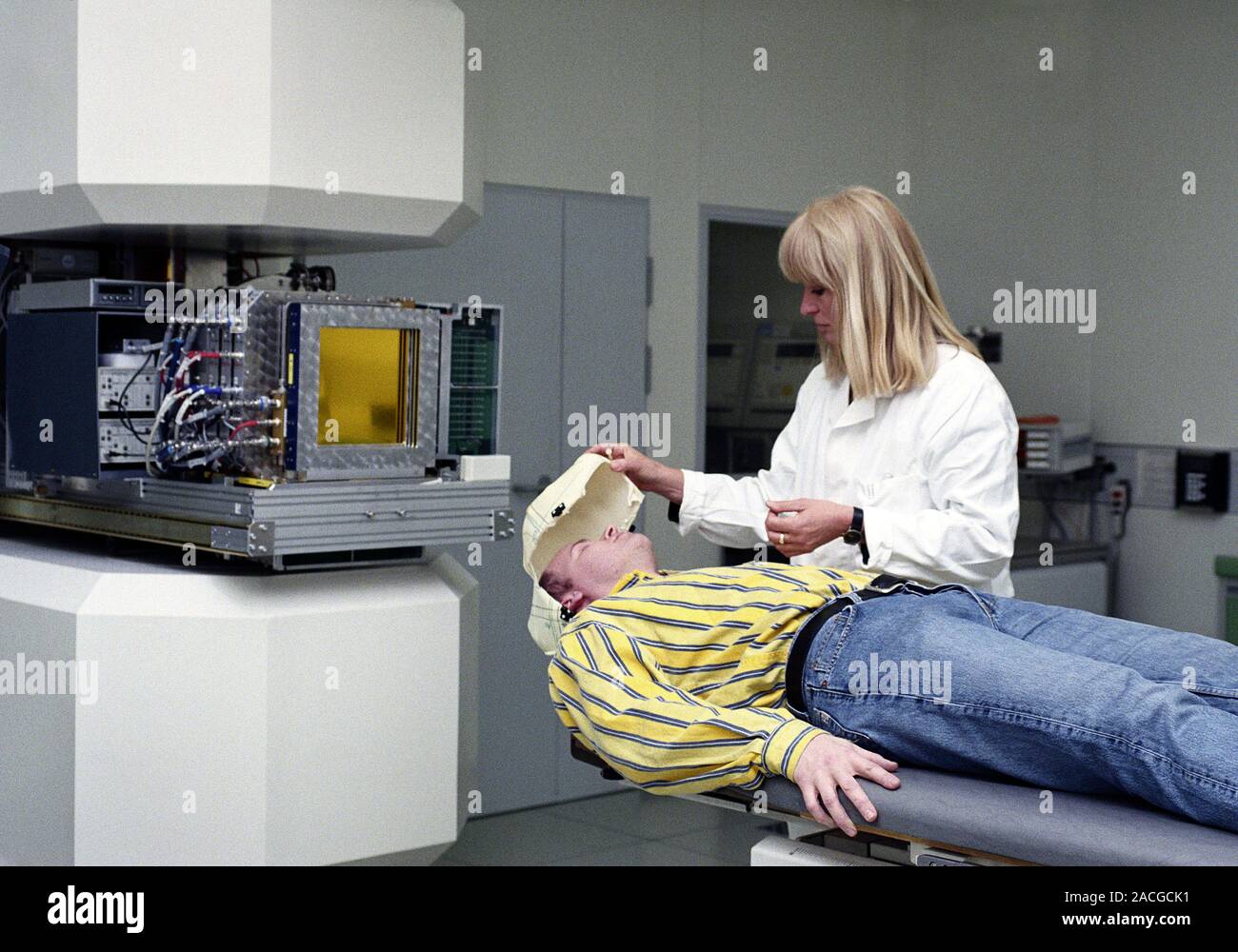 Particle therapy treatment. Patient being prepped for particle therapy ...