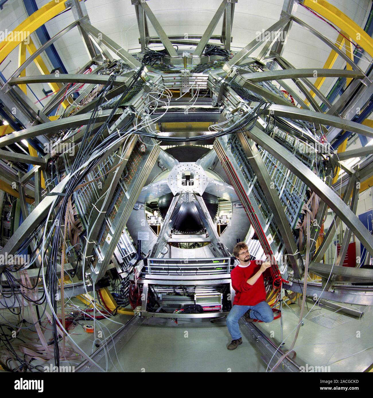 HADES particle accelerator. Engineer installing the final section of a ...