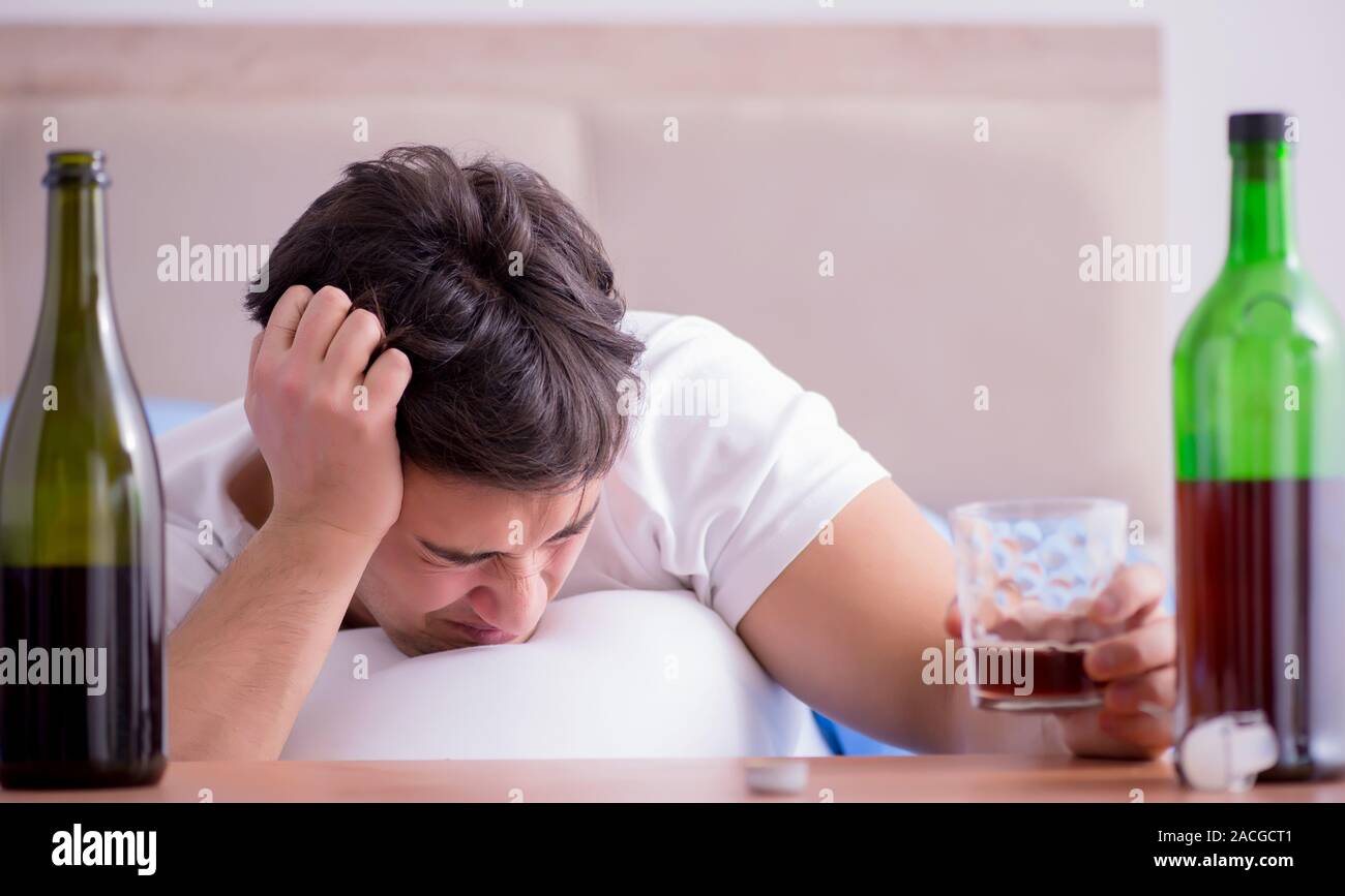 The man alcoholic drinking in bed going through break up depression ...