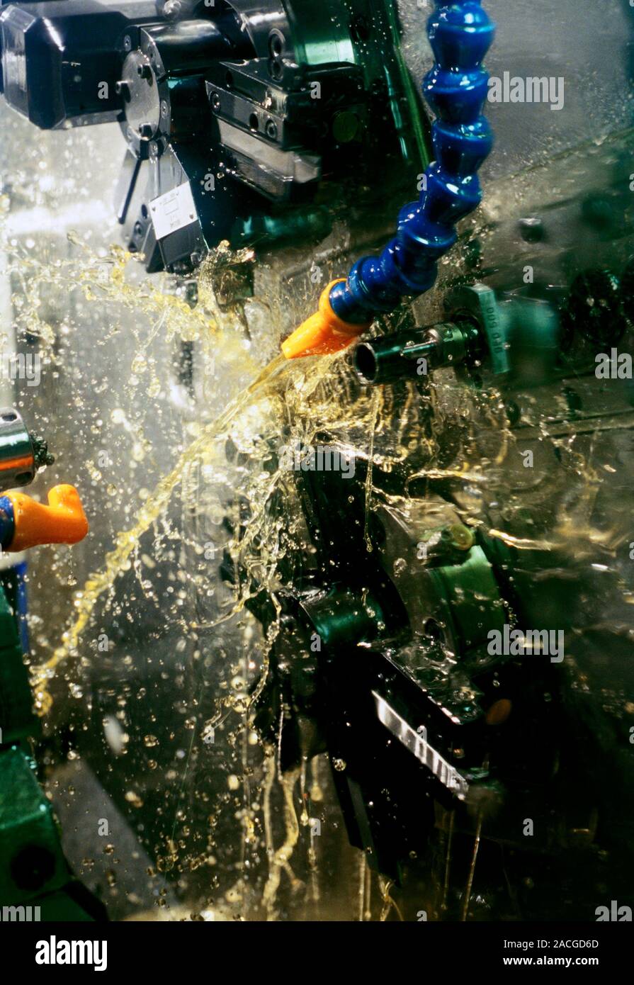 Machine lubrication. Lubricant being sprayed into a metal-working ...