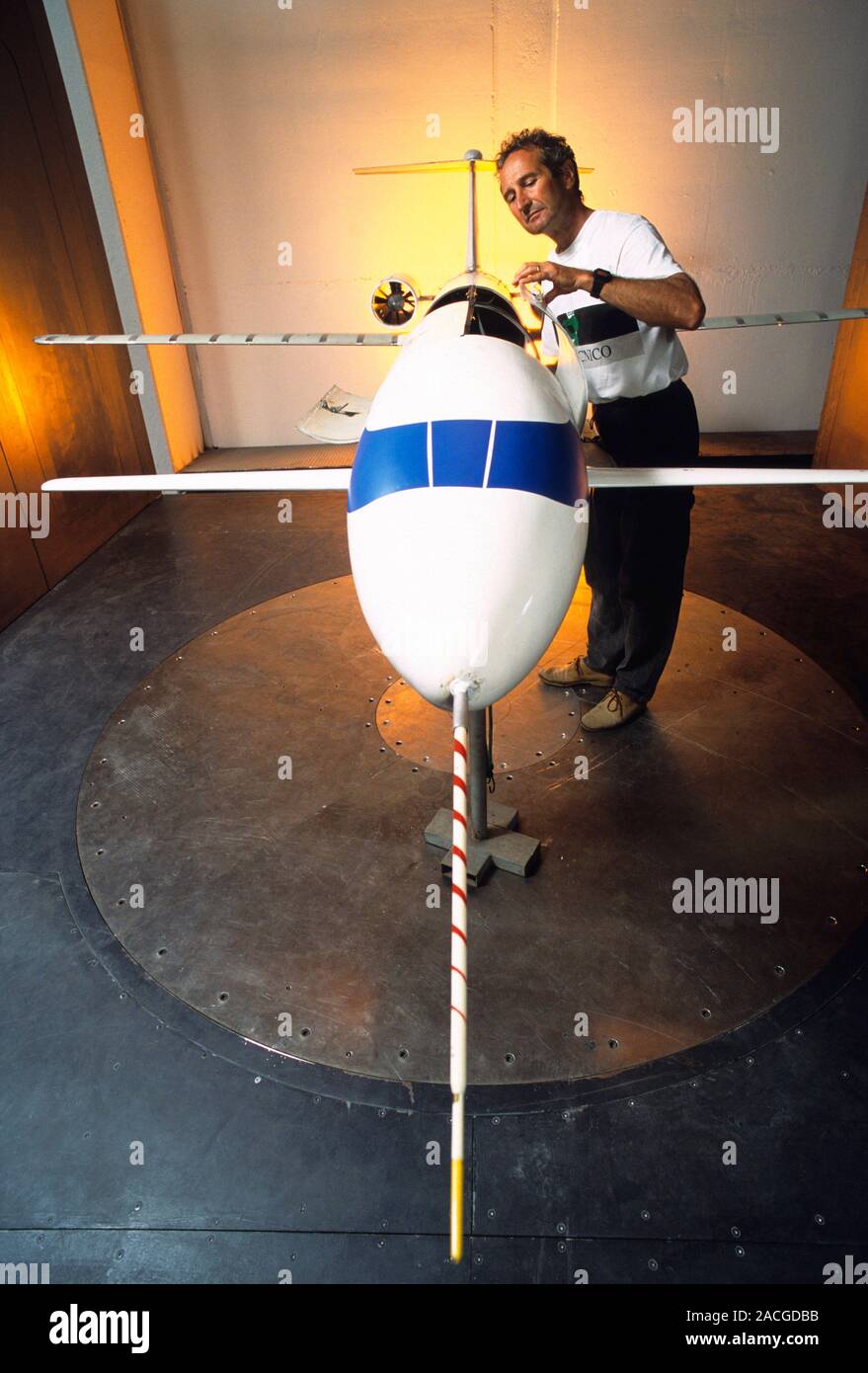Aeroplane wind tunnel test. Technician preparing a 1/10 scale model of ...