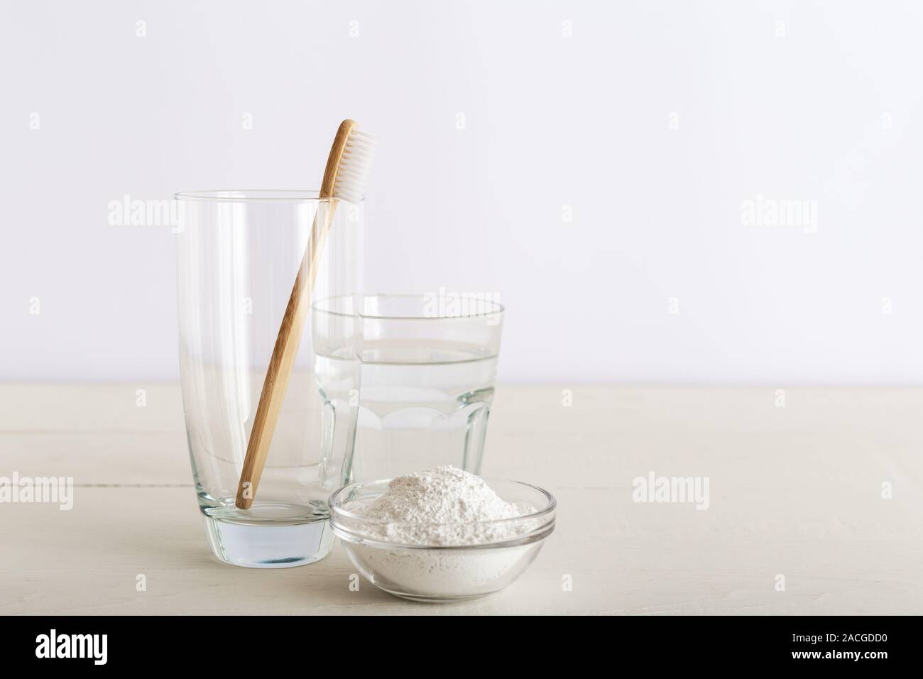 Bamboo toothbrushes, glass of water, dentifrice tooth powder on white ...
