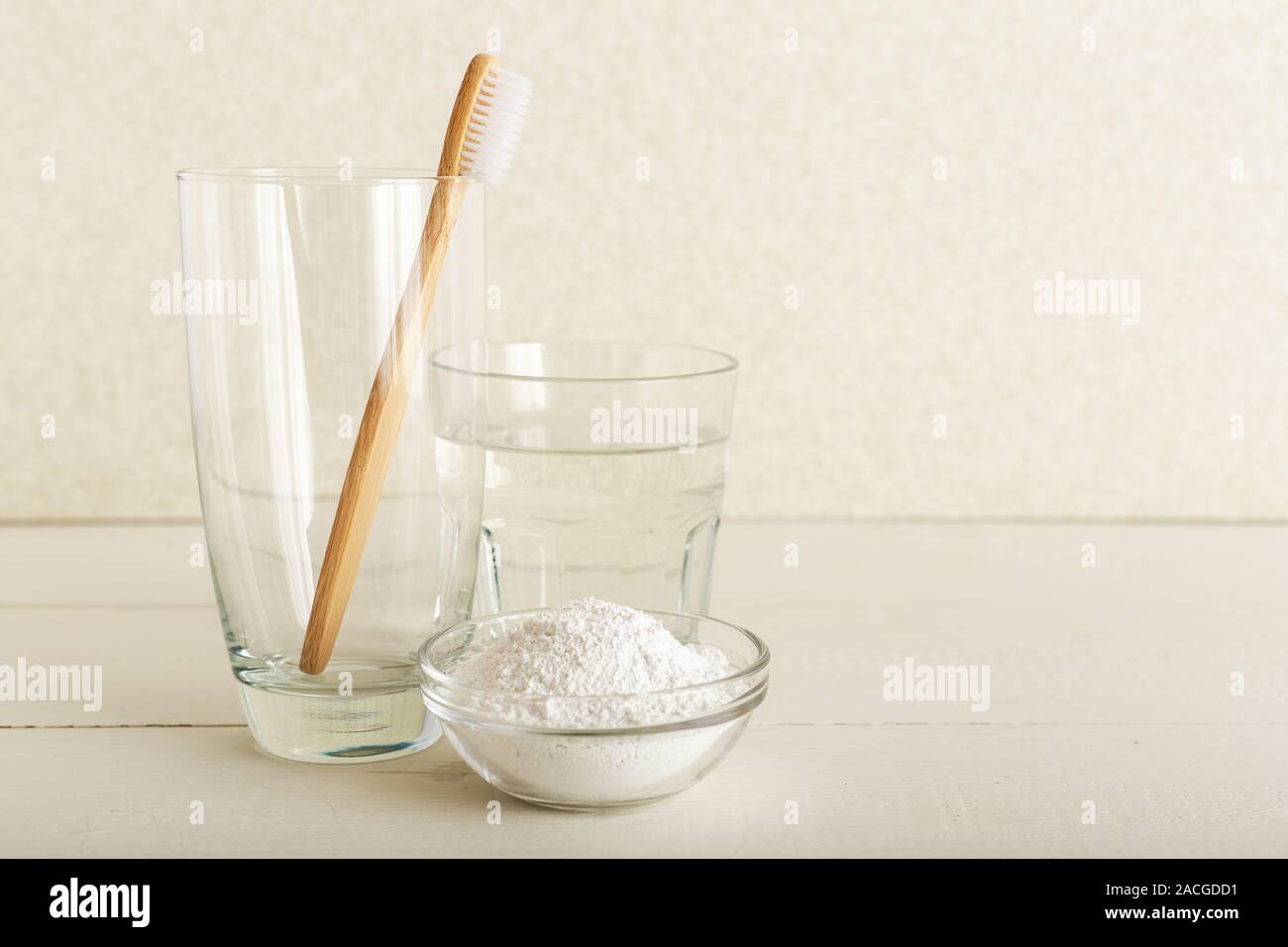 Bamboo toothbrushes, glass of water, dentifrice tooth powder on white ...