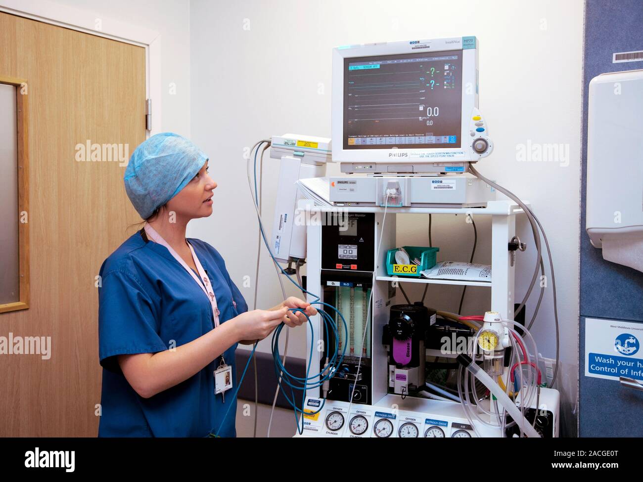 Operating theatre equipment. Surgical staff member checking equipment ...