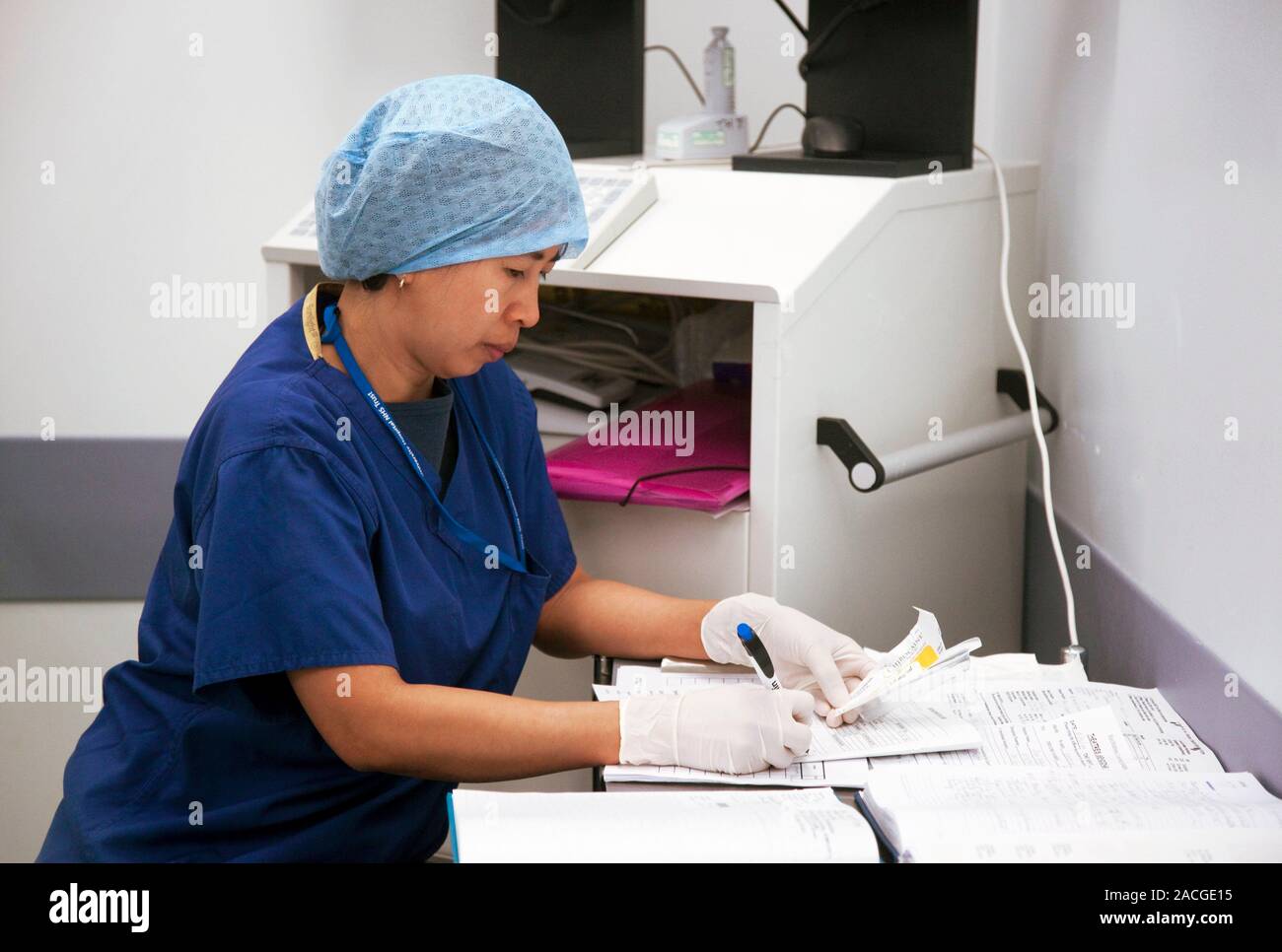Doctor taking notes during surgery Stock Photo - Alamy