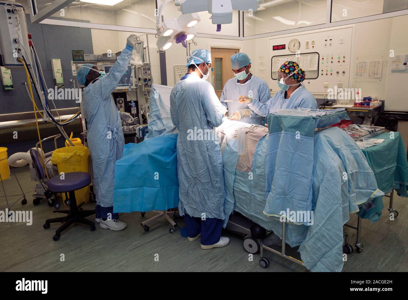 Hernia operation. Surgeons performing surgery to repair an epigastric ...