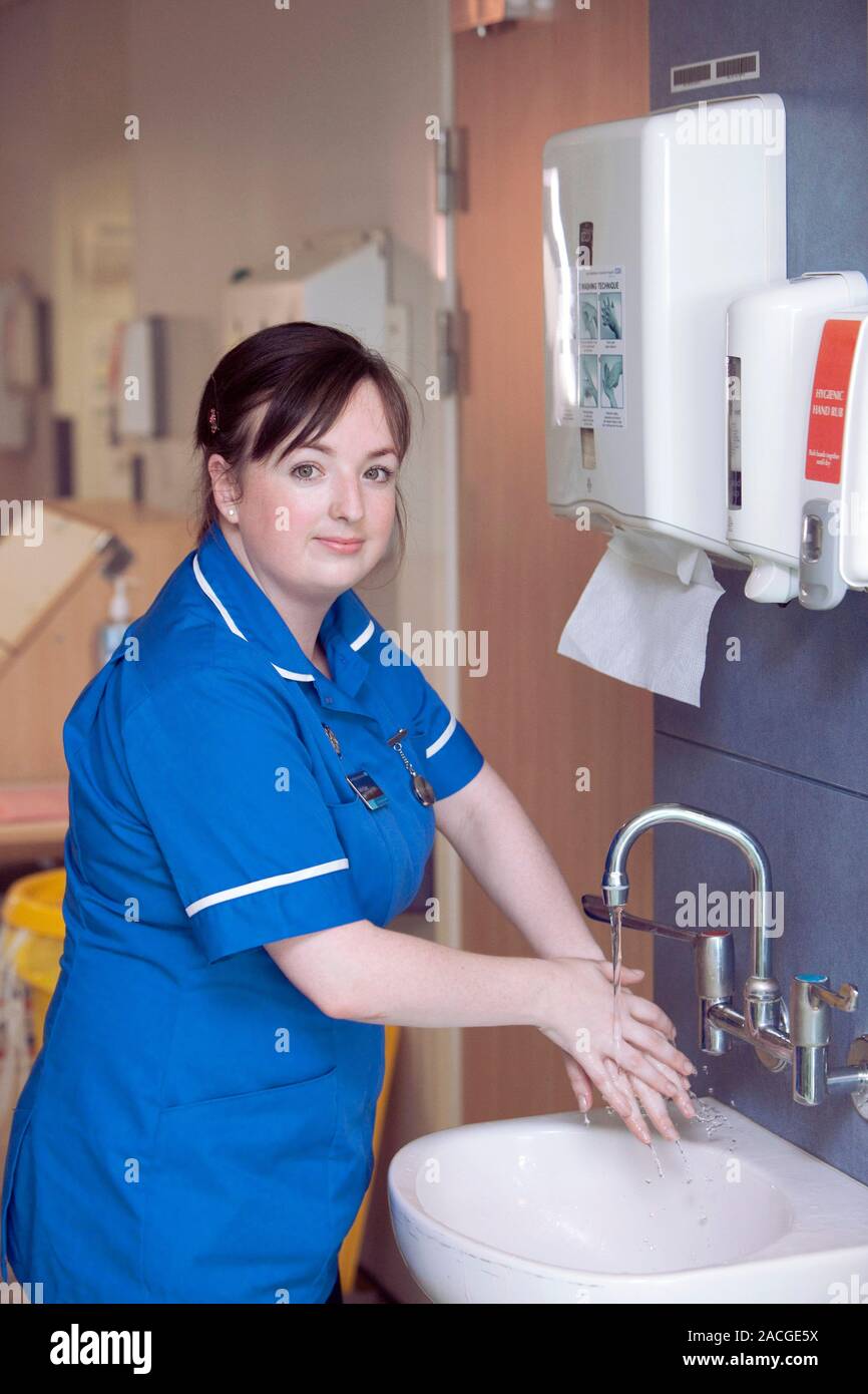Hospital nurse washing her hands on the ward of a hospital ...