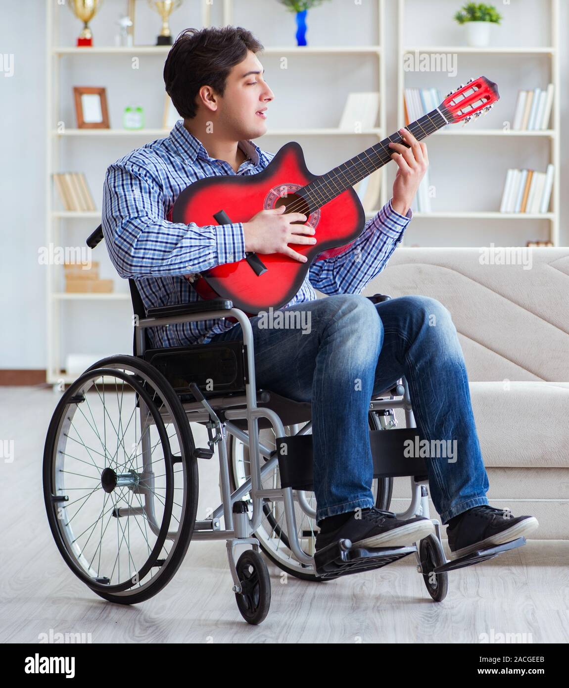 The disabled man playing guitar at home Stock Photo - Alamy