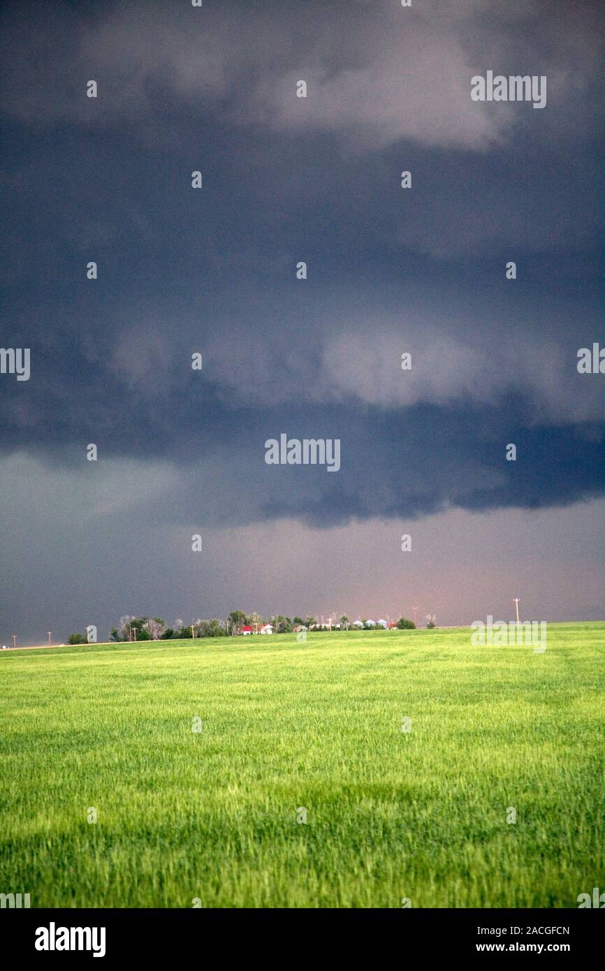 Rotating wall cloud. Wall cloud (centre) of a tornadic thunderstorm ...