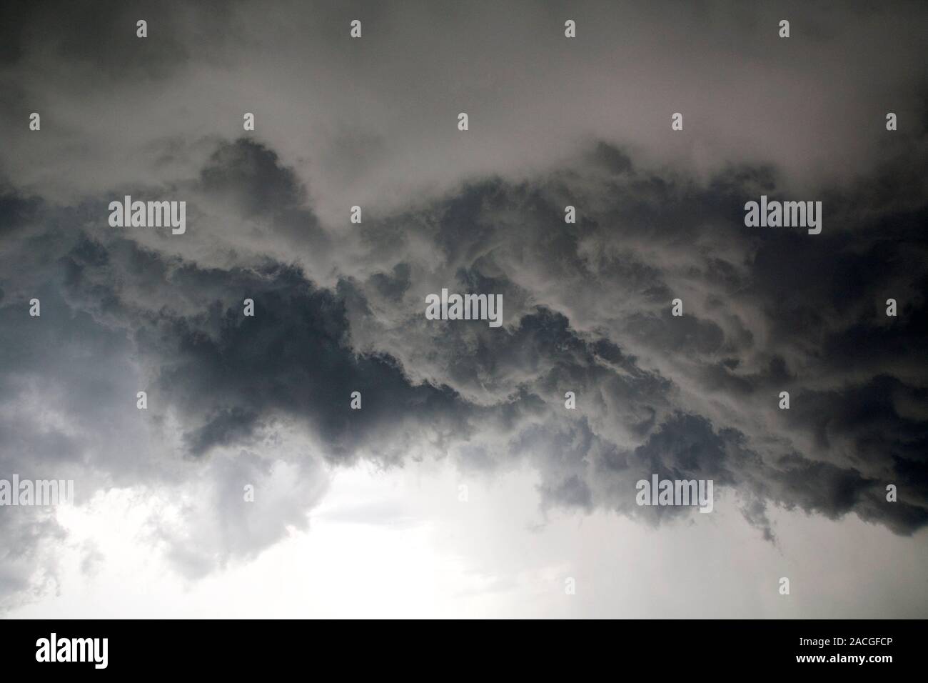 Storm clouds from the rotating wall cloud of a tornadic thunderstorm. A ...