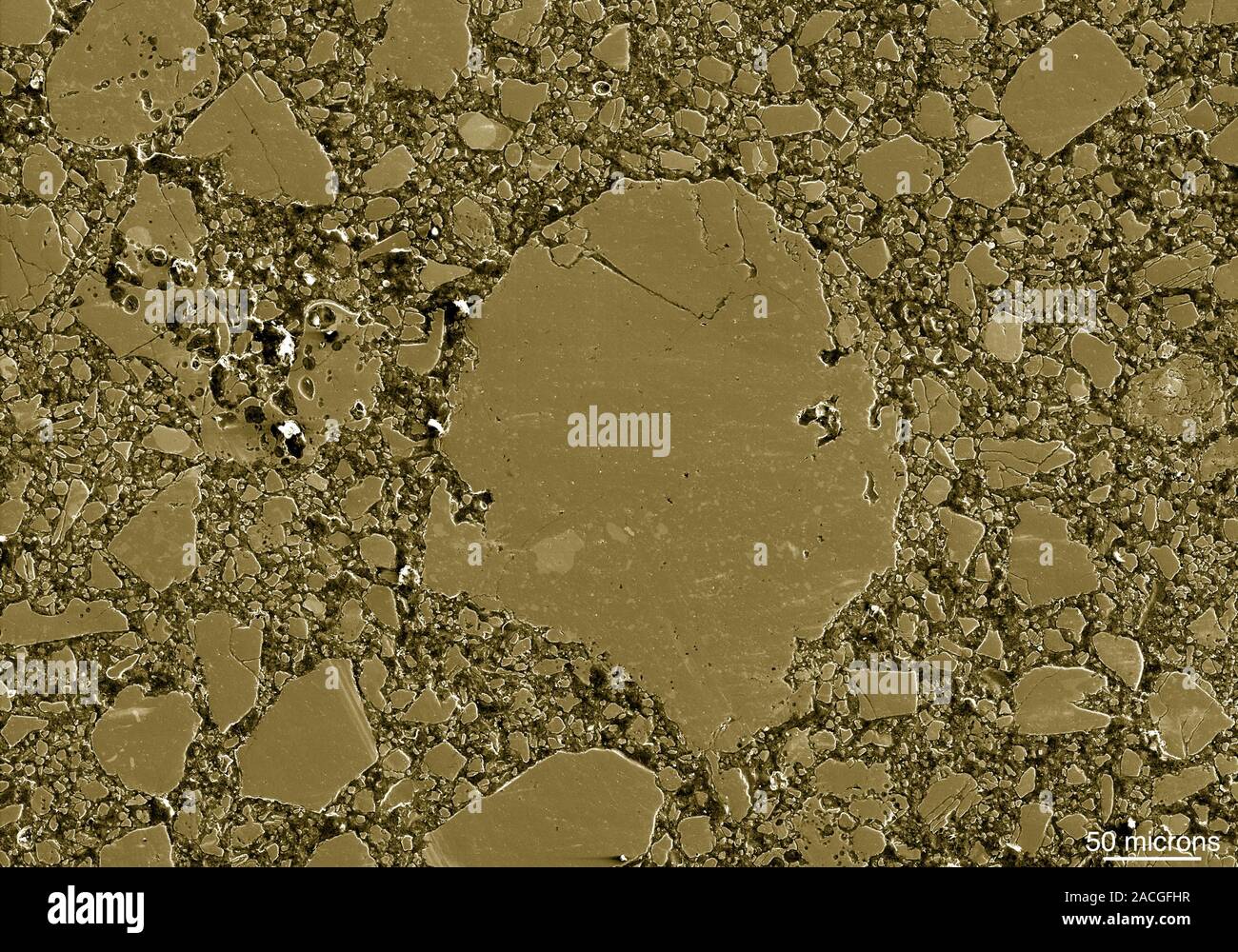 Moon rock. Coloured scanning electron micrograph (SEM) of the surface ...