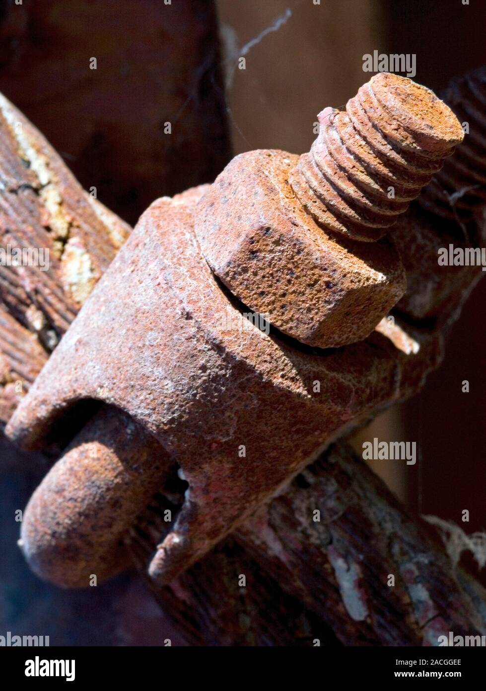 Rusting metal fastening. Rusted metallic flange holding a steel cable ...