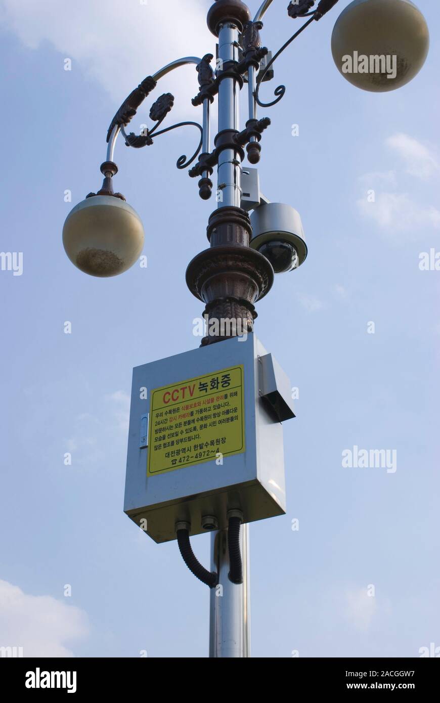 A CCTV (closed-circuit television) camera system installed on a lamp ...