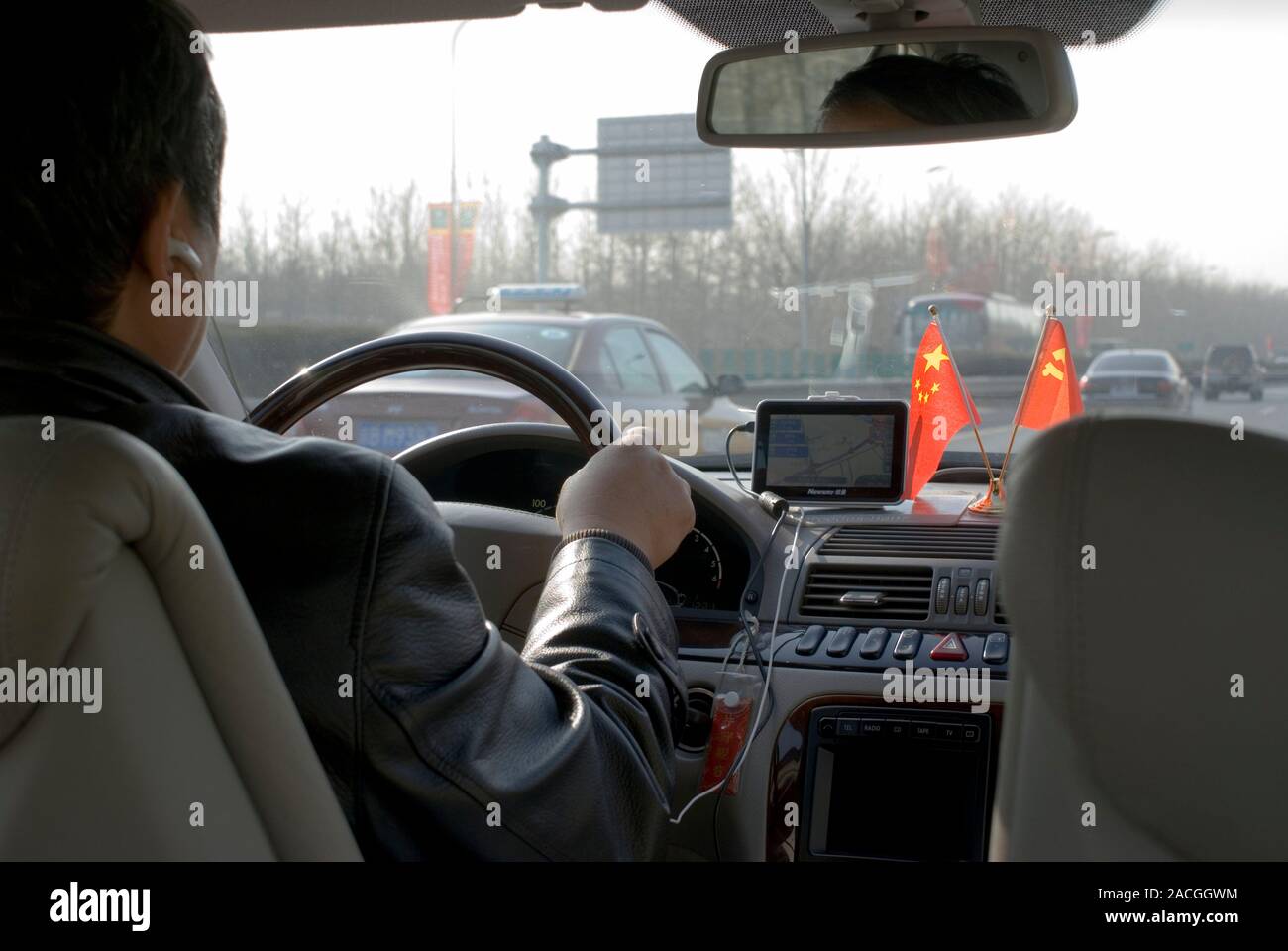 A Chinese taxi driver in Beijing. He has a Global Positioning System ...
