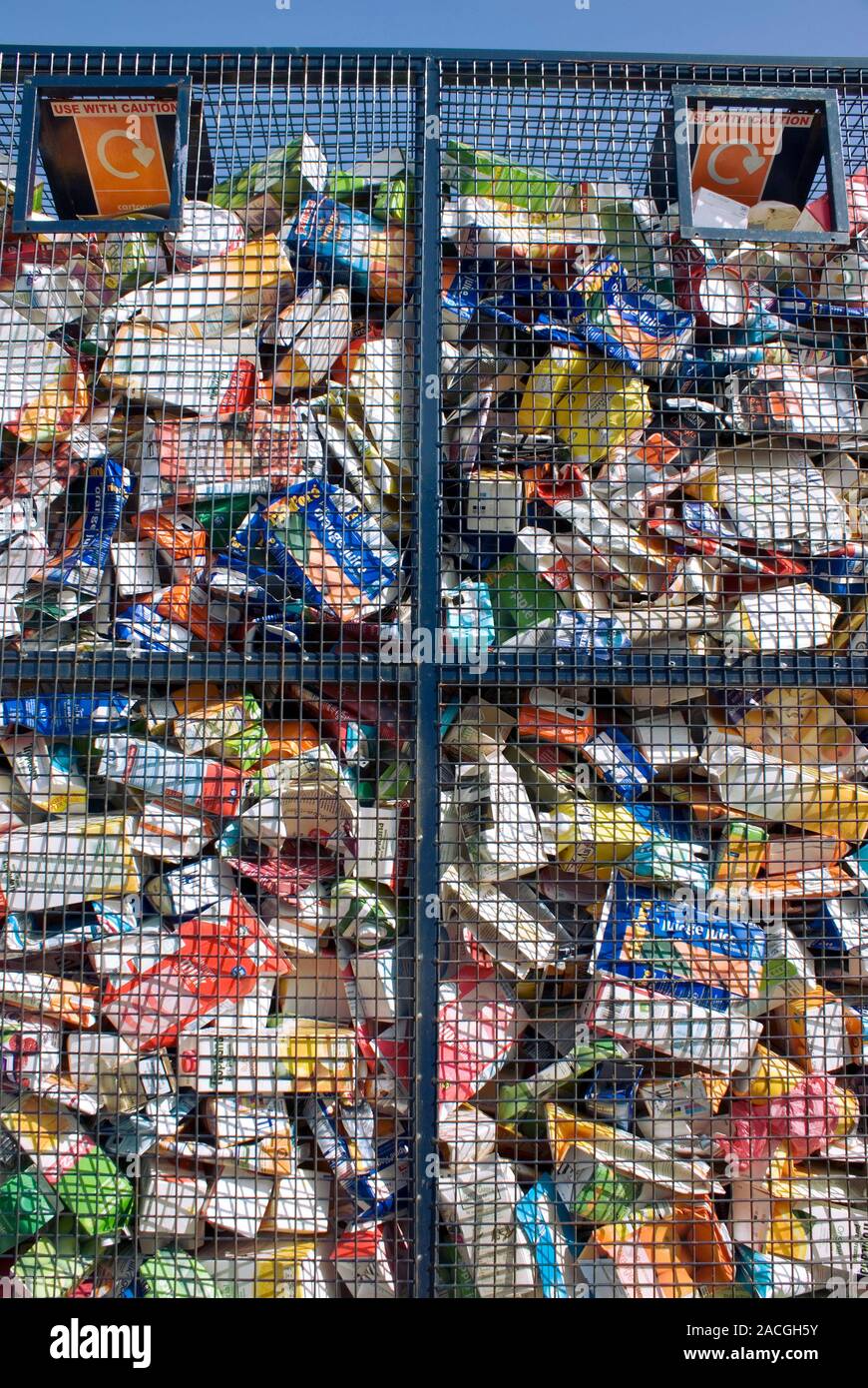 Recycling centre. Drinks cartons in a metal cage at the Flusco ...