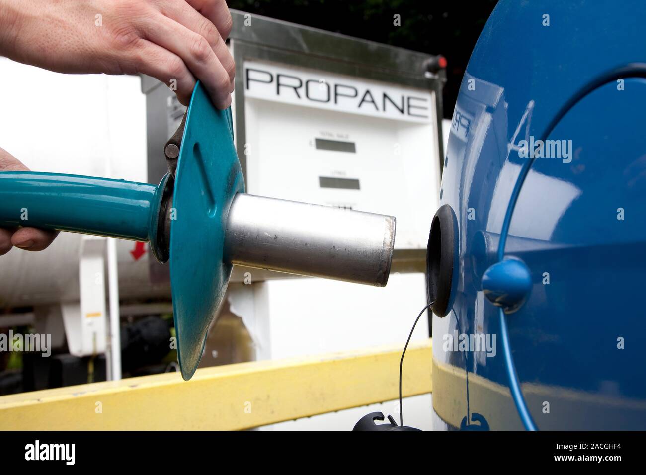 Refuelling liquefied petroleum gas car. Pump being used to refuel a car ...