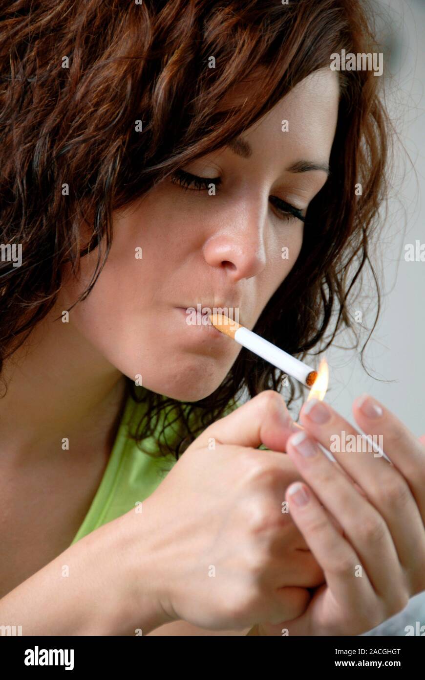 Smoking. Woman lighting a cigarette Stock Photo - Alamy