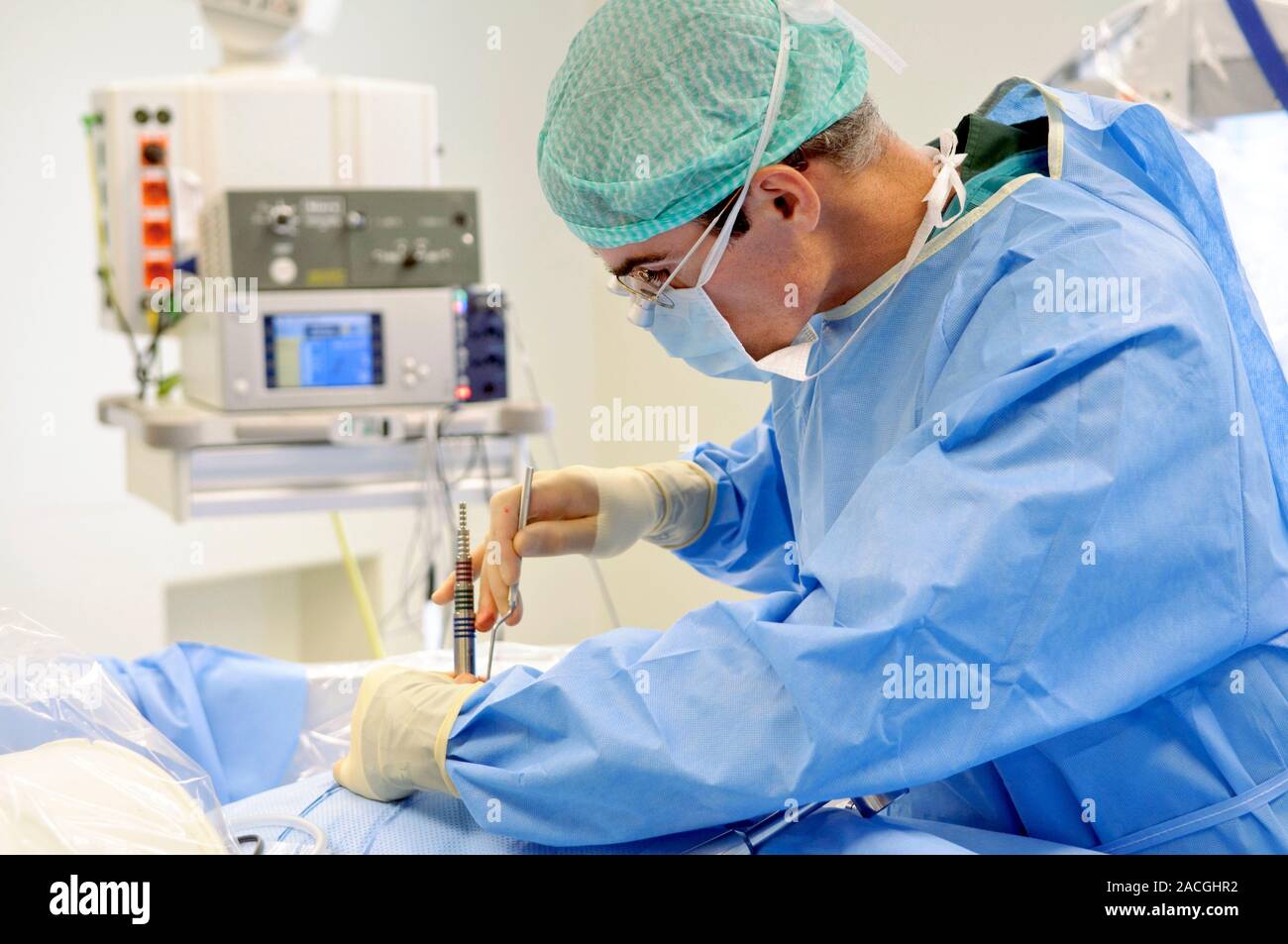 Slipped disc microendoscopy surgery. Surgeon performing an operation on ...