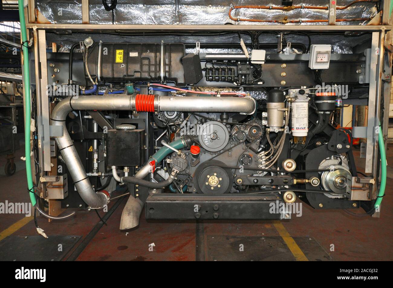 Bus production line. Engine being assembled in the rear compartment of ...