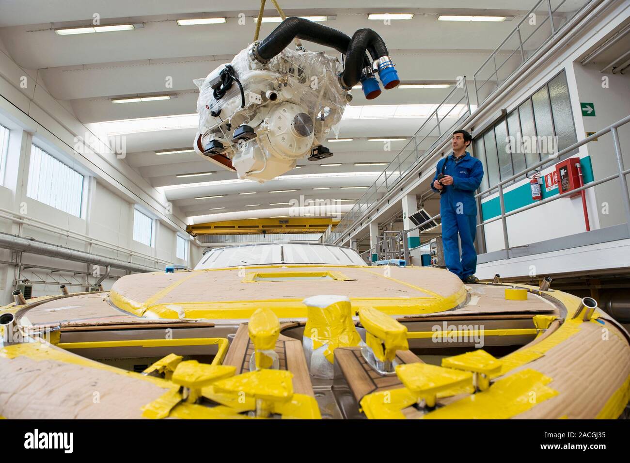 Luxury boat building. Worker at the Riva boat yard building one of the ...