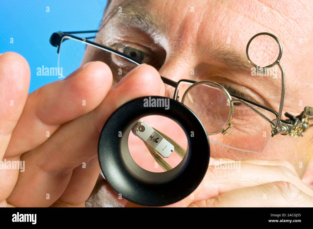 World's smallest watch movement. Jaeger-LeCoultre watchmaker holding a ...