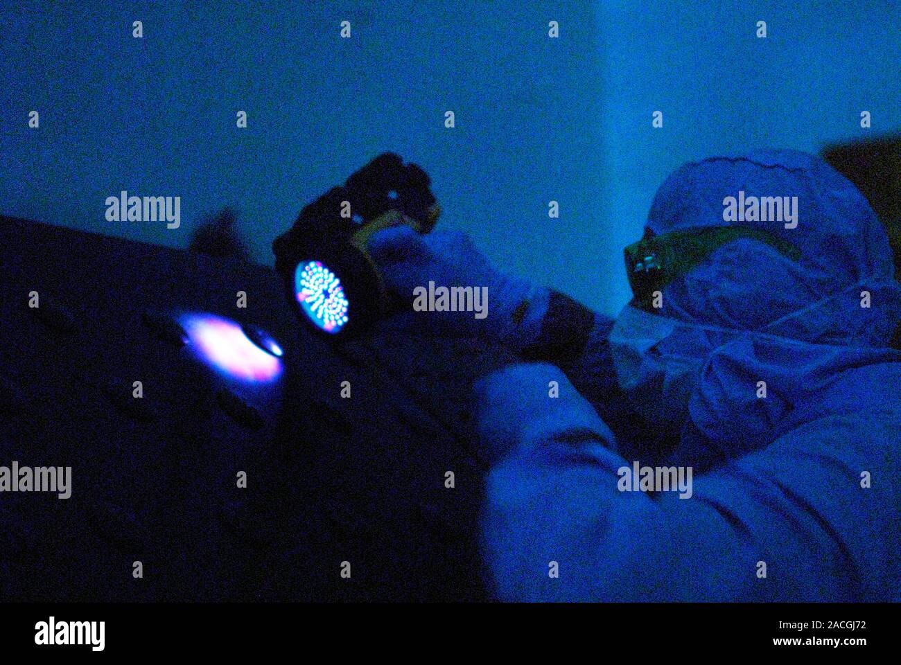 Cosmic Origins Spectrograph inspection. Clean room worker inspecting ...