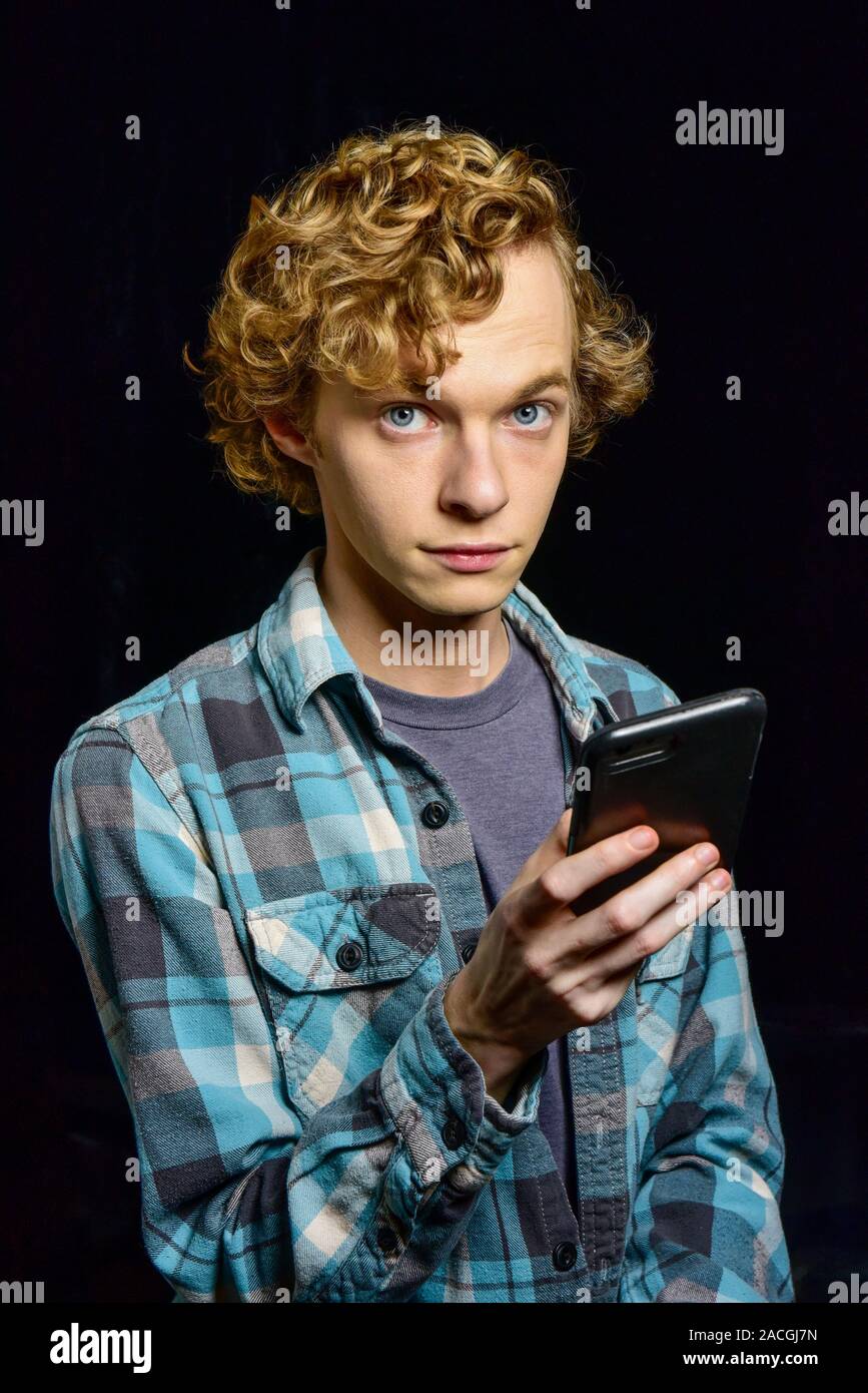 Portrait of a male Millennial with a cell phone Stock Photo - Alamy