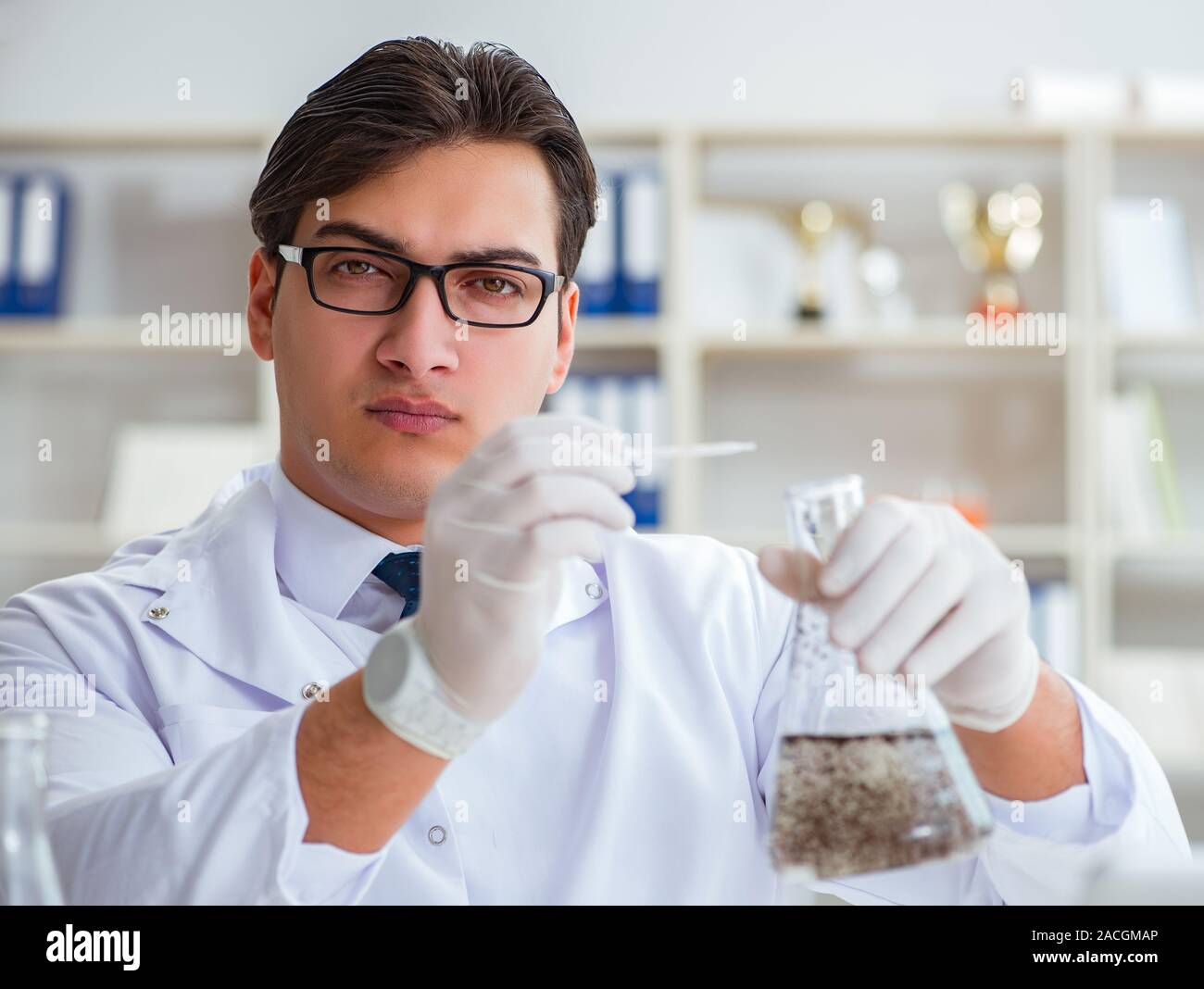 Young researcher scientist doing a water test contamination experiment ...