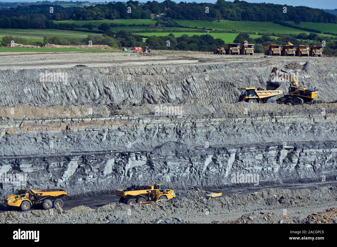 Opencast coal mine. Excavator extracting coal at a surface mine Stock ...