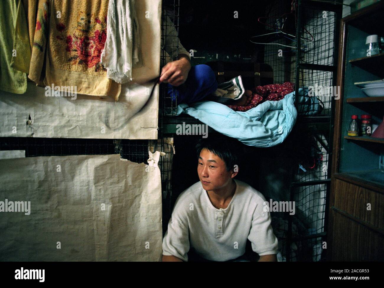 Cage housing, Hong Kong. Cage houses are a type of stacked temporary ...