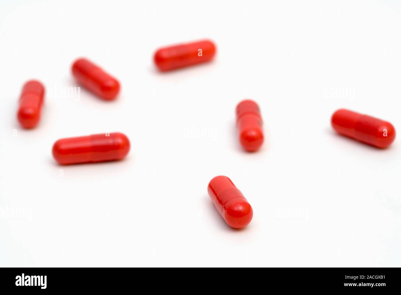 Red capsule medications Stock Photo - Alamy