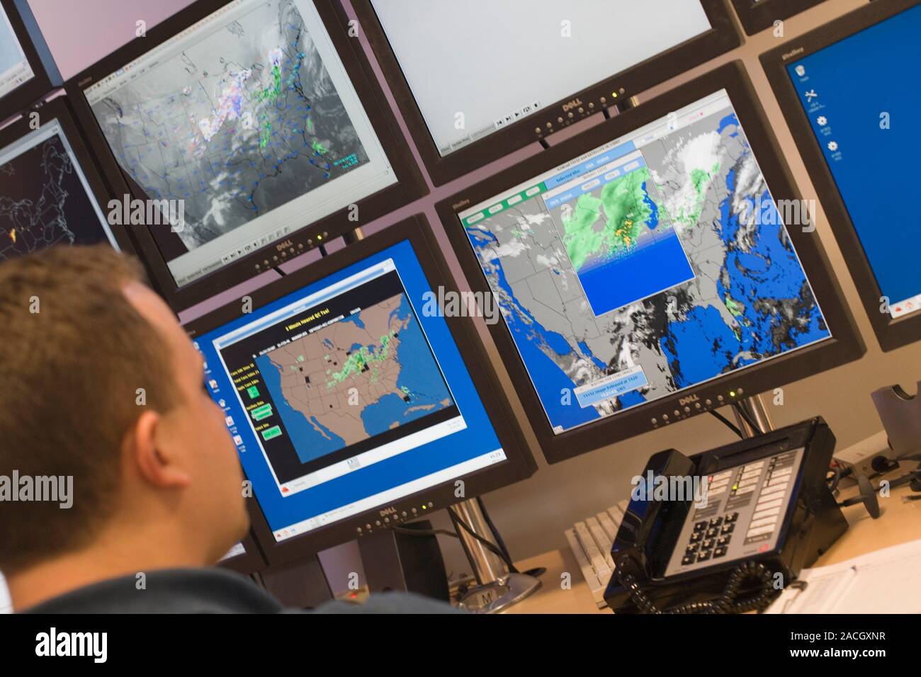 Meteorologist studying weather pattern on computer screens Stock Photo ...