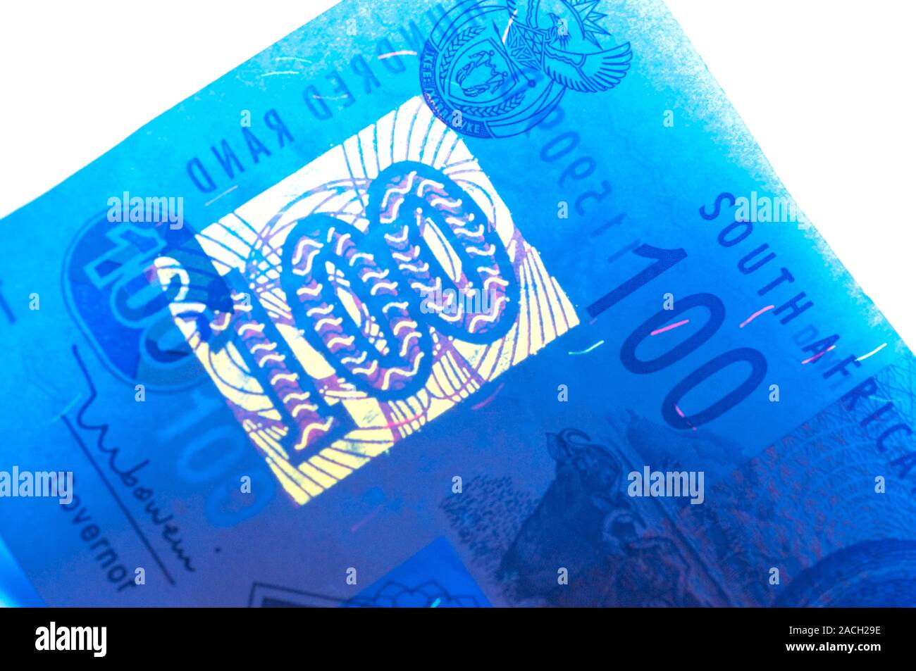 South African banknote in UV light. Close up of a 100 Rand banknote ...