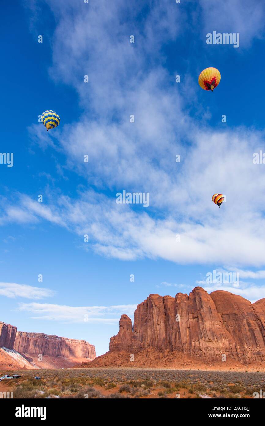 Thre hot air balloons fly in the Monument Valley Balloon Festival in ...