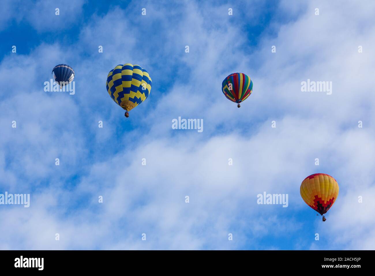 Four hot air balloons in the Monument Valley Balloon Festival fly over ...