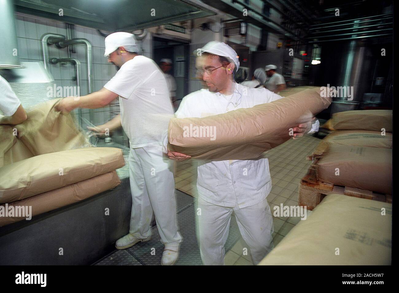 Ice cream factory. Workers mixing ingredients at an Italian ice cream ...