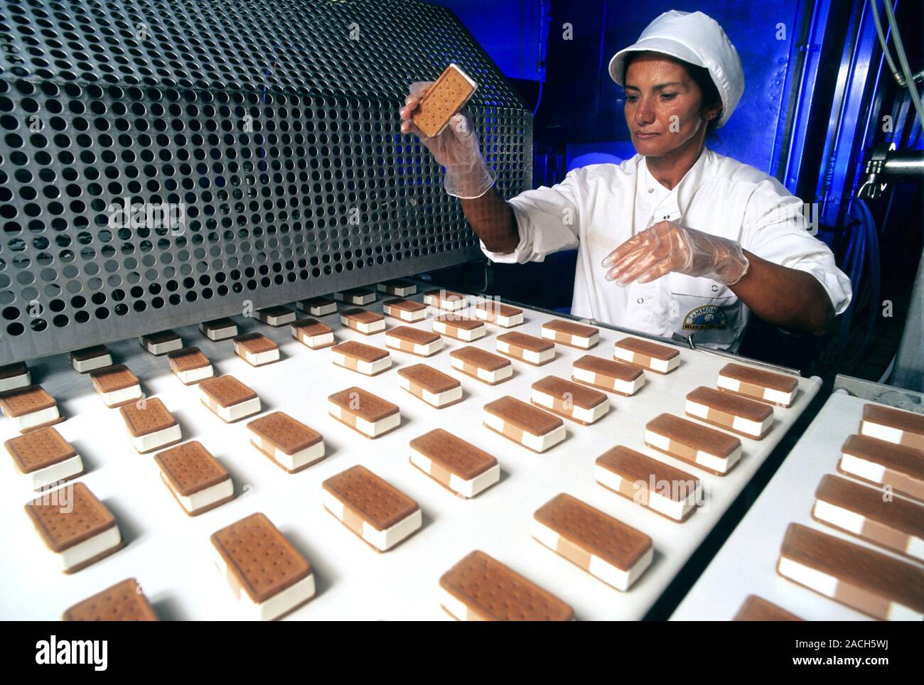 Ice cream factory. Worker checking ice cream sandwiches at an Italian ...