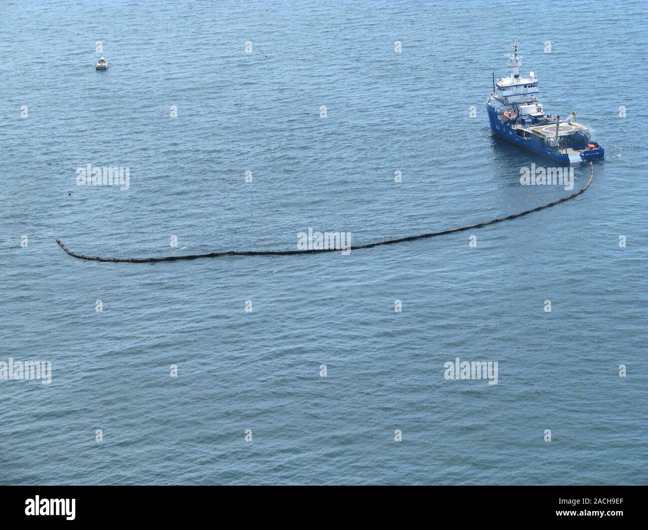 Gulf of Mexico oil spill, 2010. Boat laying an inflatable boom to help ...