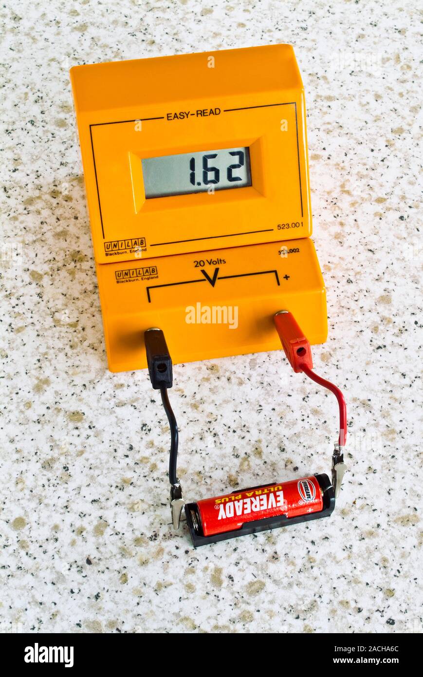 Digital voltmeter attached to a battery. This device is used to measure ...