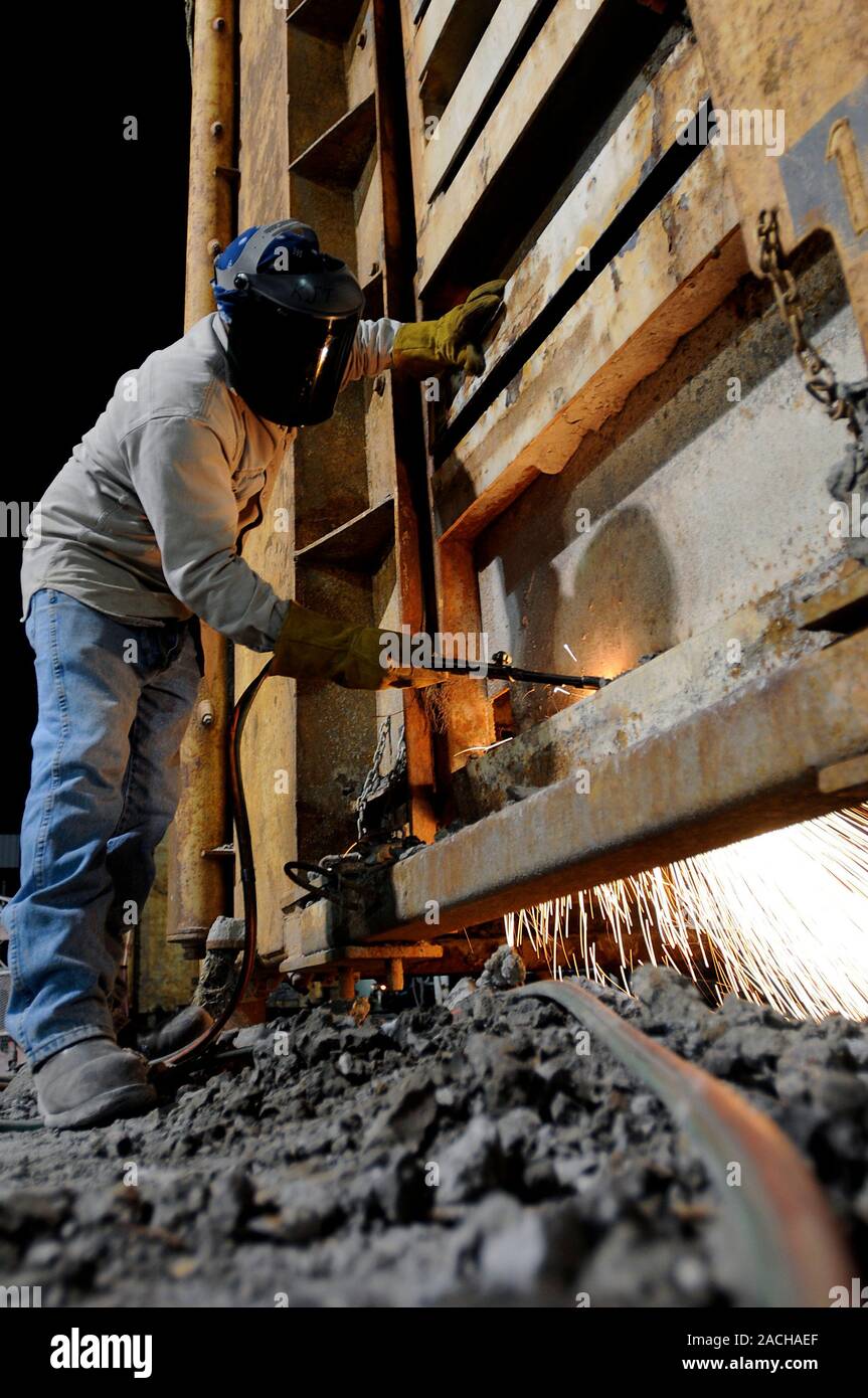 Gulf of Mexico oil spill containment, 2010. Welder building a portion ...
