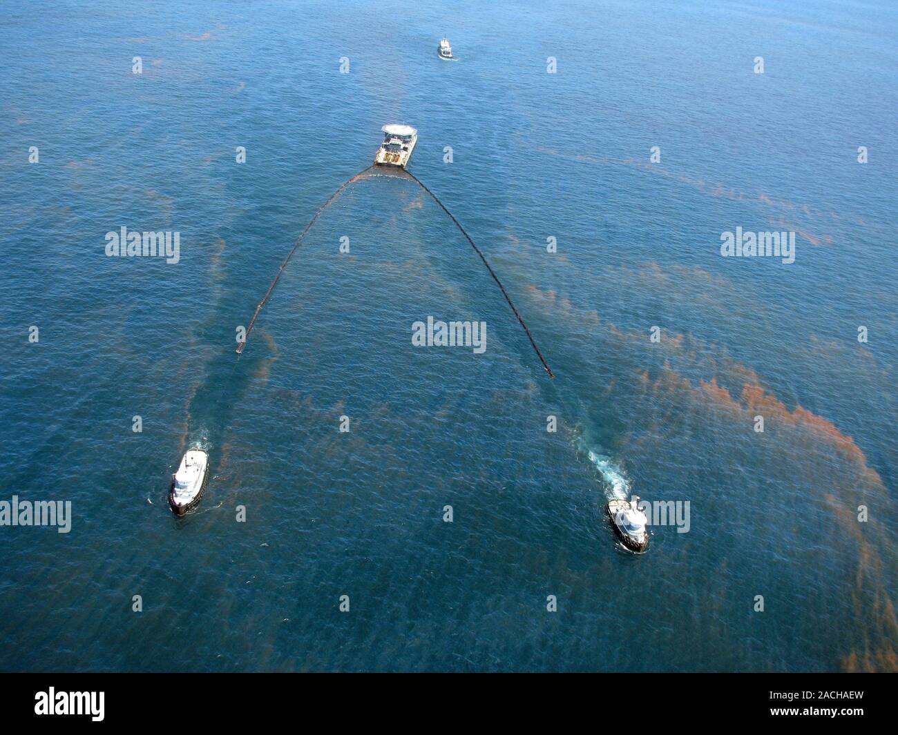 Gulf of Mexico oil spill, 2010. Fishing vessels using deflection booms ...