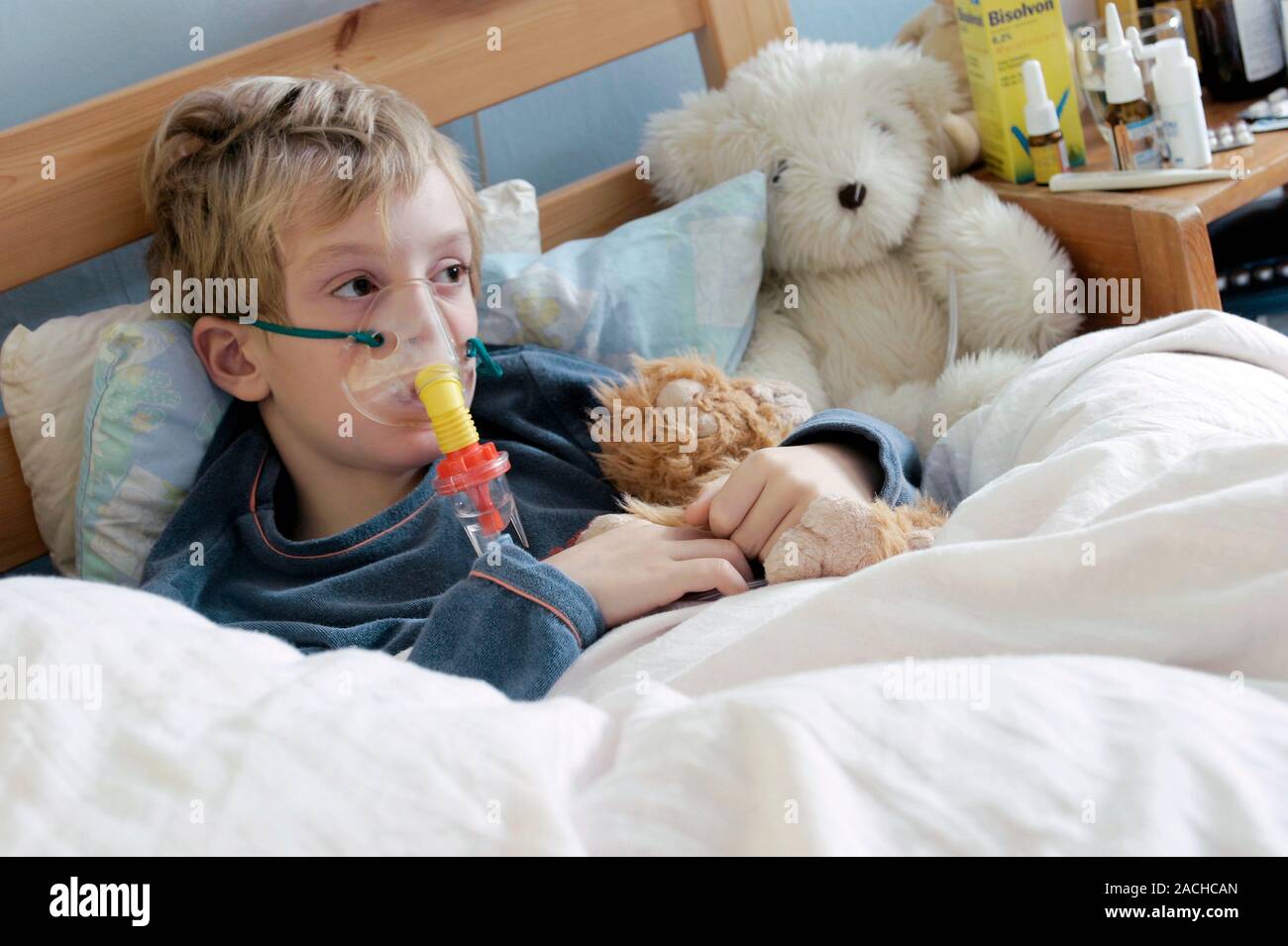 Oxygen therapy. Young boy wearing an oxygen mask. The face mask ...