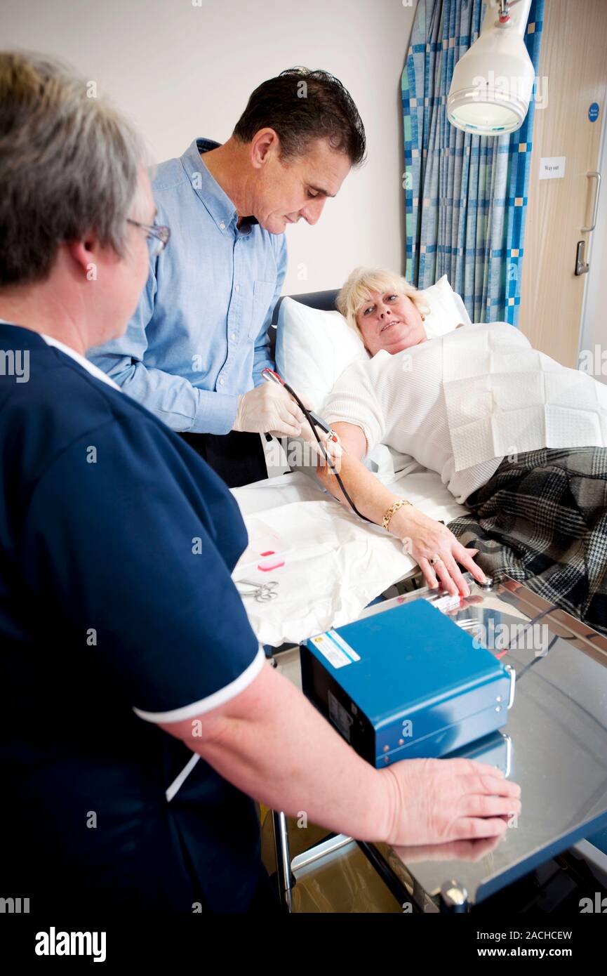 Diathermy. Doctor using diathermy on a patient in a hospital. Diathermy ...