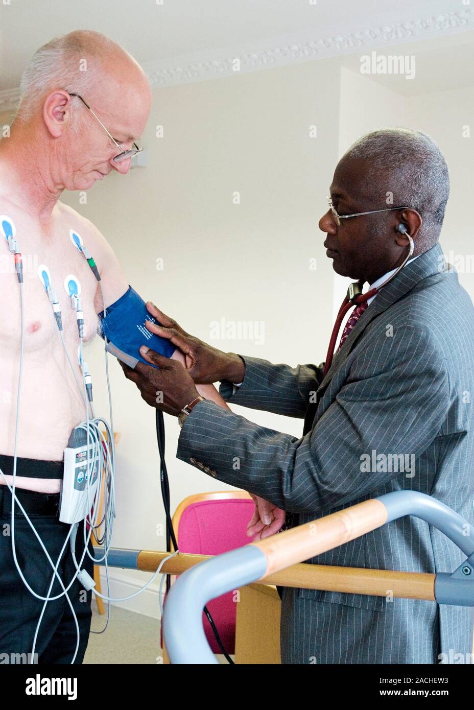 Heart fitness test. Doctor fitting an inflatable cuff around a patient ...