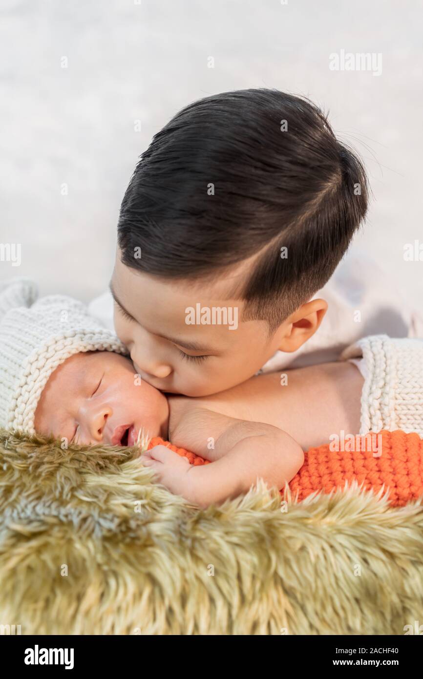 little boy kissing his newborn baby brother Stock Photo - Alamy
