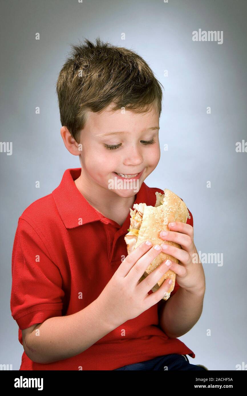 Boy eating a sandwich Stock Photo - Alamy
