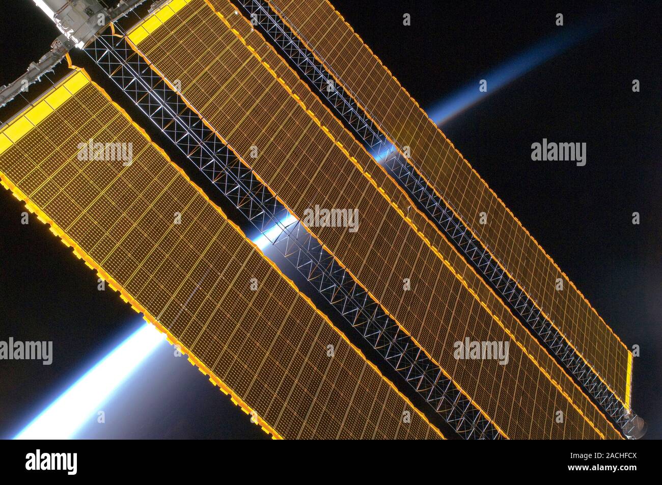 ISS solar array. Airglow above the Earth's horizon seen behind an array ...