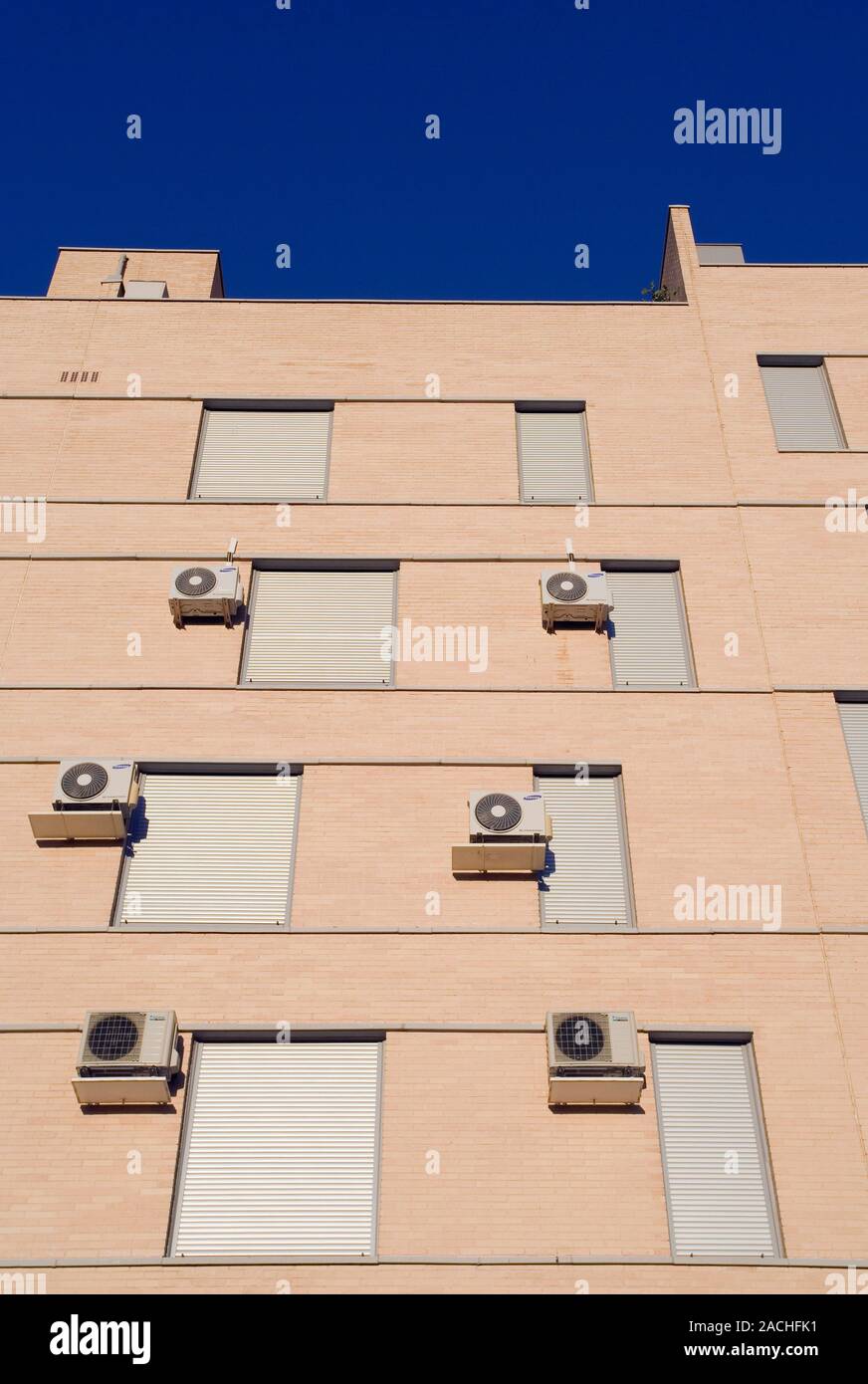 Block of flats with air conditioning unit outlets on the exterior wall ...
