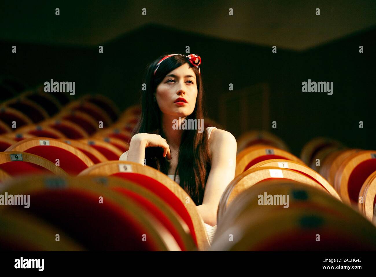 portrait of a pretty girl hipster in a movie theater posing in fashion ...